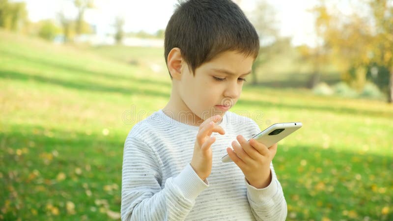 Little Kid Using Smartphone Outdoors. Stock Footage - Video of ...