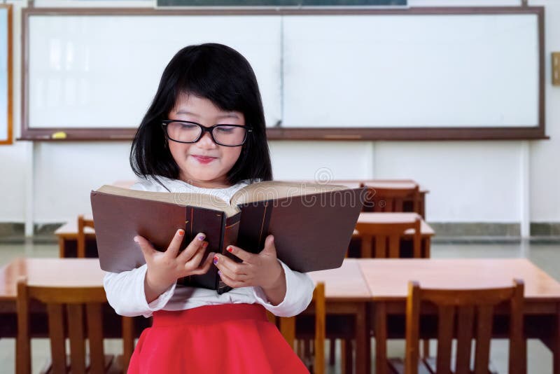 Little Learner Reading a Book in Class Stock Photo - Image of little ...