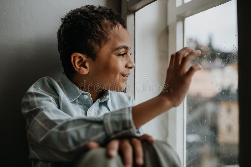 Little Multiracial Boy Looking Out of Window. Stock Image - Image of ...