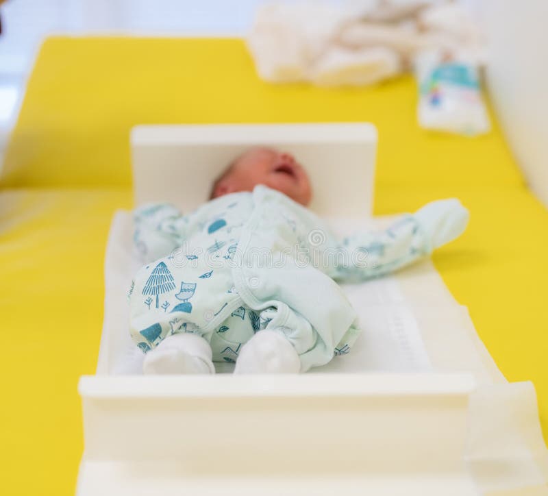 Little Newborn Lying. Small Newborn Feet in Hands Stock Image - Image ...