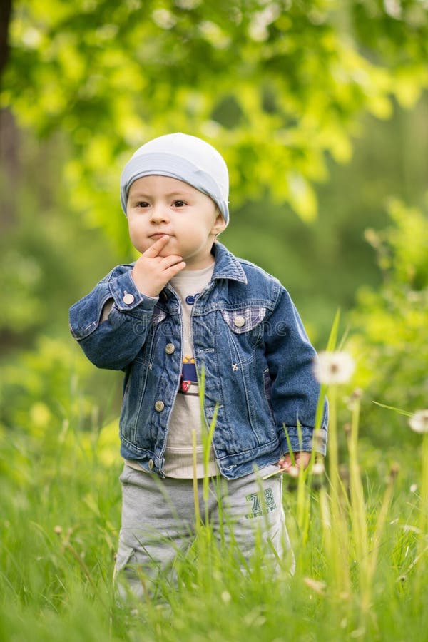 A Little Pensive Boy is Standing in a Spring Park. Stock Image - Image ...