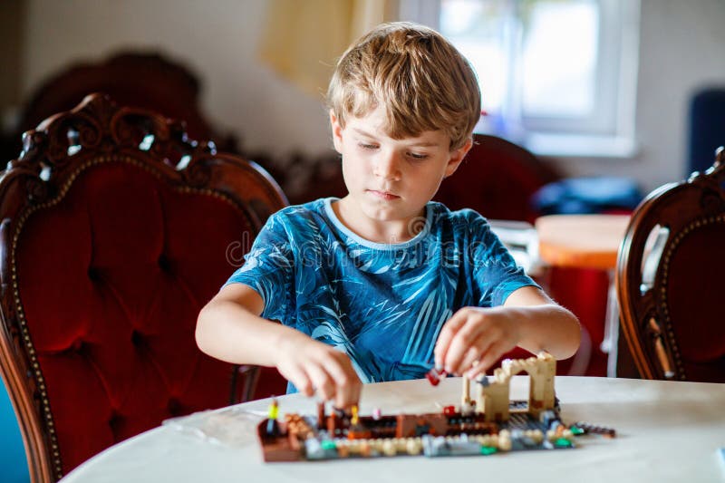 Little Preschool or Elementary School Kid Boy Building a Plastic Blocks ...