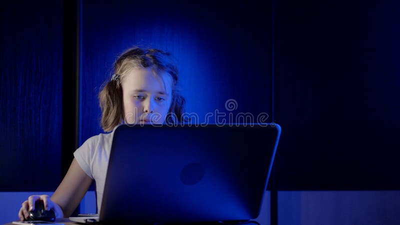 Little Preschooler Girl is Sitting Alone in Front of Notebook in Night ...