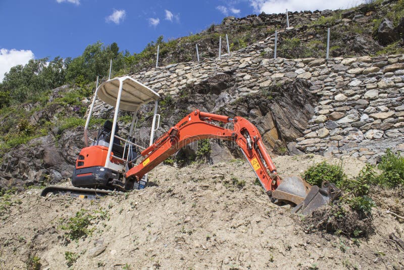 Little Red Excavator on a Mountain with Trees Stock Image - Image of ...