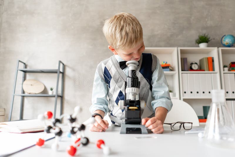 Little Schoolboy in Casual Clothes Looks in Microscope Stock Photo ...
