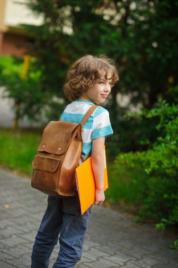 Little Schoolboy with a School Backpack Behind the Back. Stock Photo ...