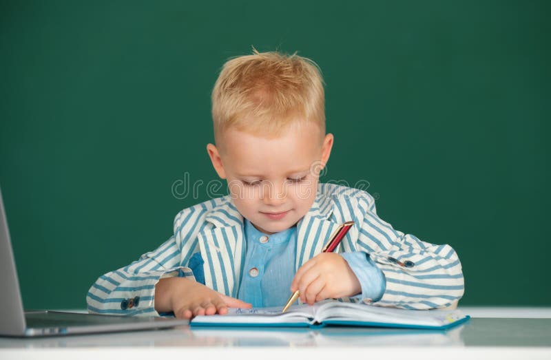 Little Schoolboy Study in a Classroom at Elementary School. Kid Writing ...