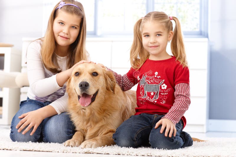 Little Sisters Fondling Dog at Home Stock Photo - Image of face, floor ...