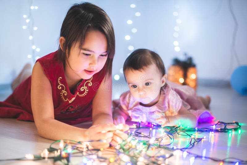 Little Sisters Having Fun at Home with Chrismas Lights Stock Photo ...