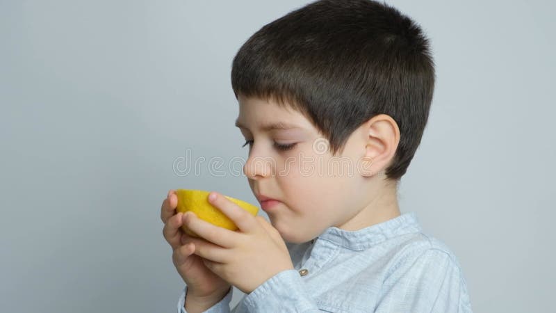 A Little Six-year-old Boy Tastes a Lemon Stock Video - Video of lemon ...