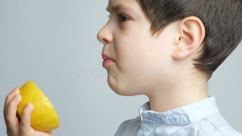 A Little Six-year-old Boy Tastes a Lemon Stock Footage - Video of ...