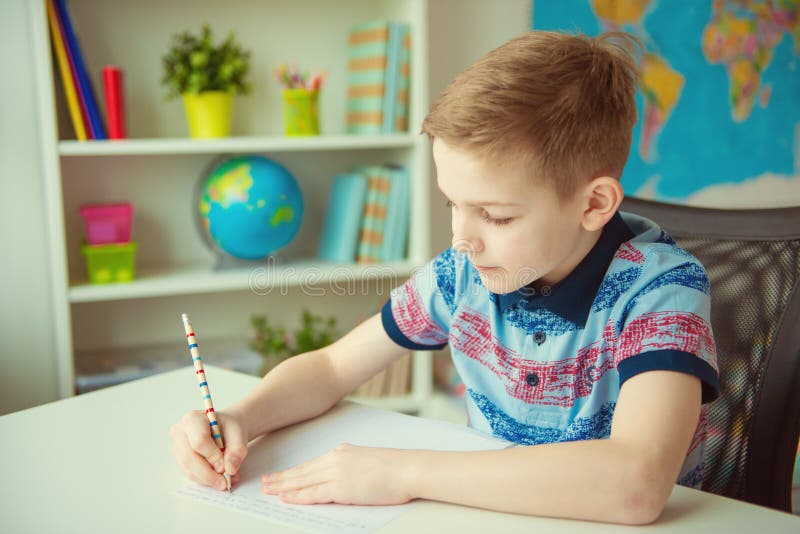 Little Smart School Boy Making Homework at Desk in Room Stock Image ...