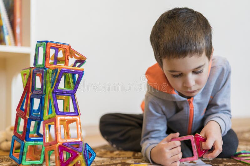 Little Smiling Boy Playing with Magnetic Constructor Toy. Boy Playing ...
