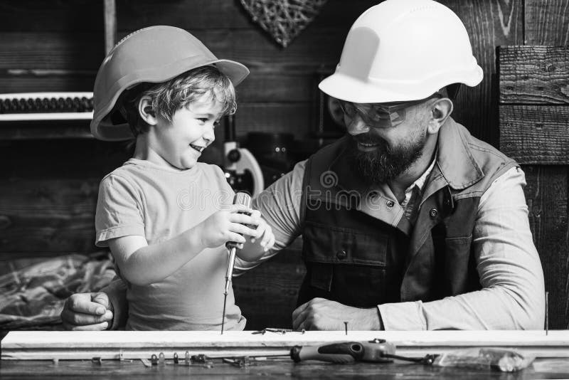 Little Son Helping His Father with Building Work. Parent in Protective ...