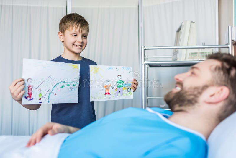 Little Son Showing Sick Father His Drawings at Ward Stock Image - Image ...