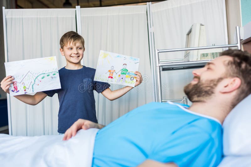 Little Son Showing Sick Father His Drawings at Ward Stock Image - Image ...