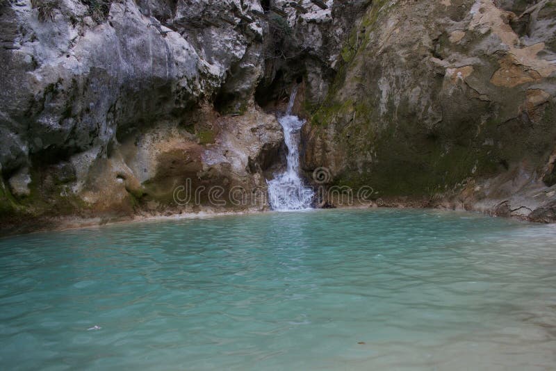 Little Stream Flowing Down the Rugged Cliffs into a Turquoise Pool of ...