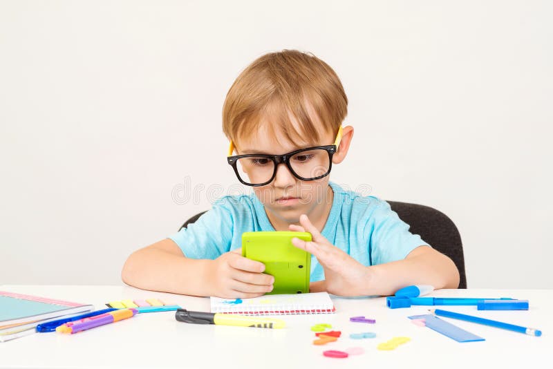 Little Student Boy Counts Something with Calculator. Child Doing ...