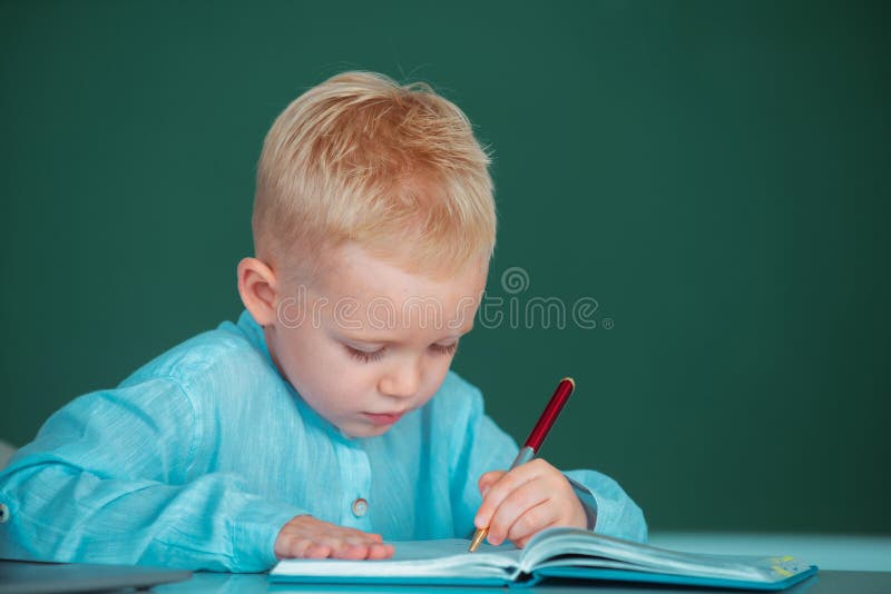 Kid Writing in Class. Child at School. Kid is Learning in Class on ...