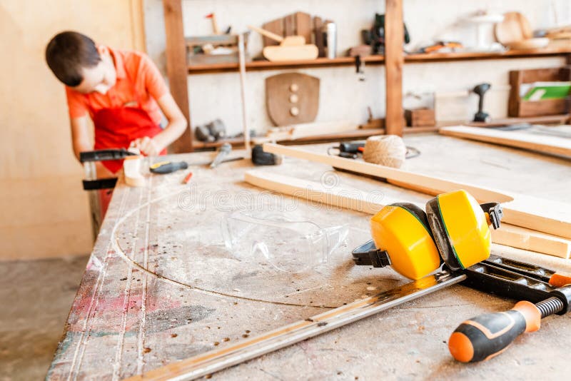 Talented Genius Boy Works with Wood in a Carpentry Workshop. the ...