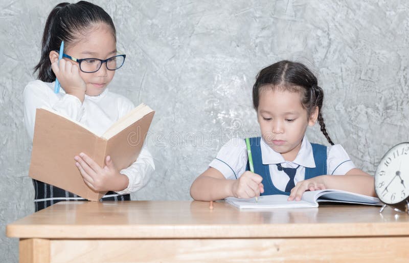 Little Teacher Looking Student Doing Homework Stock Photo - Image of ...