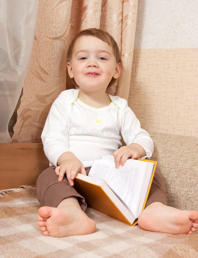 Little toddler with a book stock photo. Image of interior - 27452912
