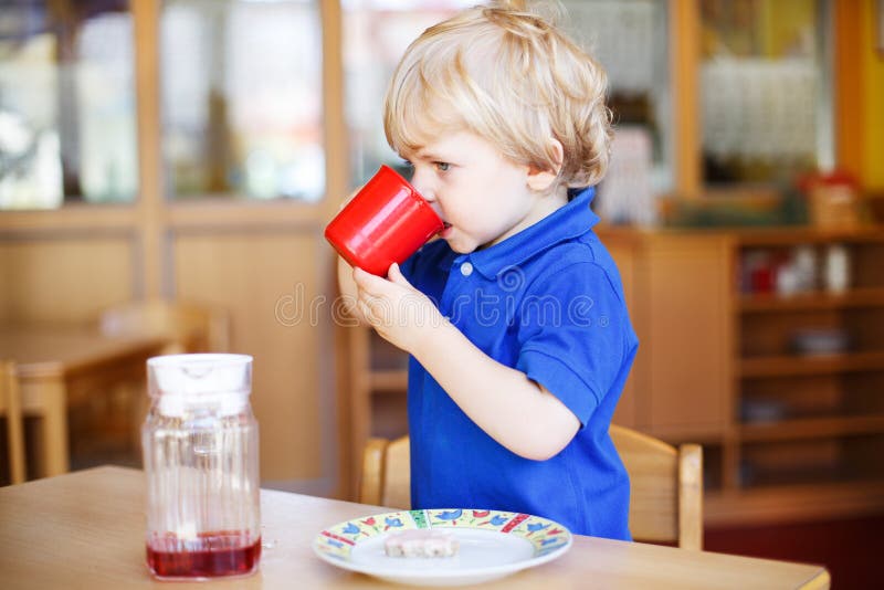 Little Toddler Boy Eating Breakfast at Nursery Stock Photo - Image of ...