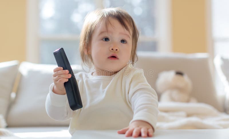 Toddler Boy with a TV Remote Control Stock Photo - Image of room, cute ...
