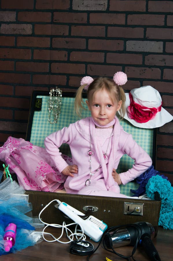Little Warmly Dressed Girl Packs a Suitcase with Summer Things Stock ...