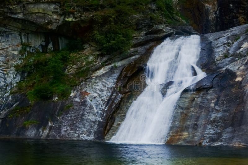 Little Waterfall Over a Cliff in a Forest with Rocks Stock Photo ...