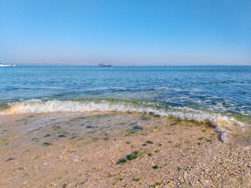 Little waves on the beach stock image. Image of tower - 193668775