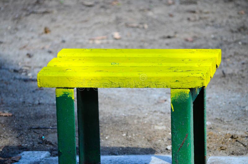 Little yellow bench stock image. Image of green, legs - 48122951
