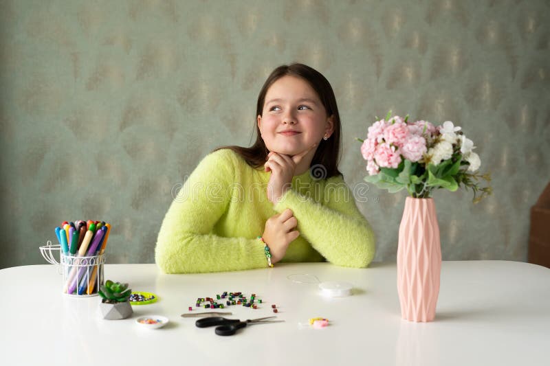 Little Young Girl Sitting at a Table with a Thoughtful Face Stock Image ...