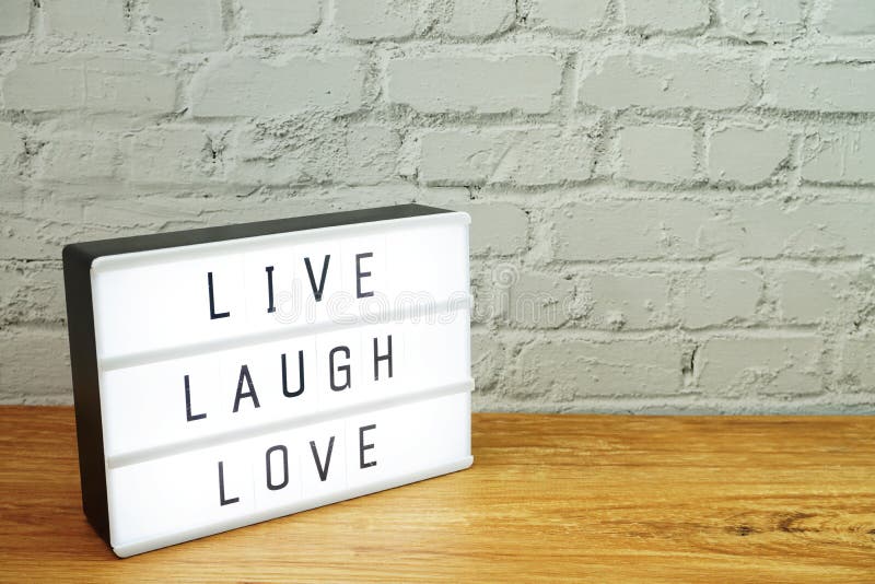 Live Laugh Love Word in Light Box on White Brick Wall Background Stock ...