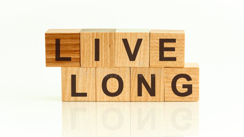 LIVE LONG - Text on Wooden Cubes on a White Gradient Background Stock ...