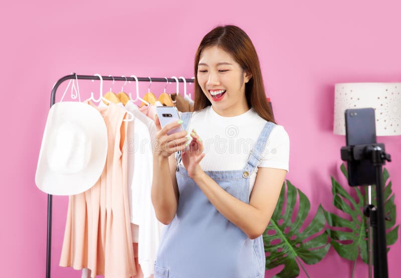 Live Streaming Young Asian Pretty Girl Using Smartphone For Marketing