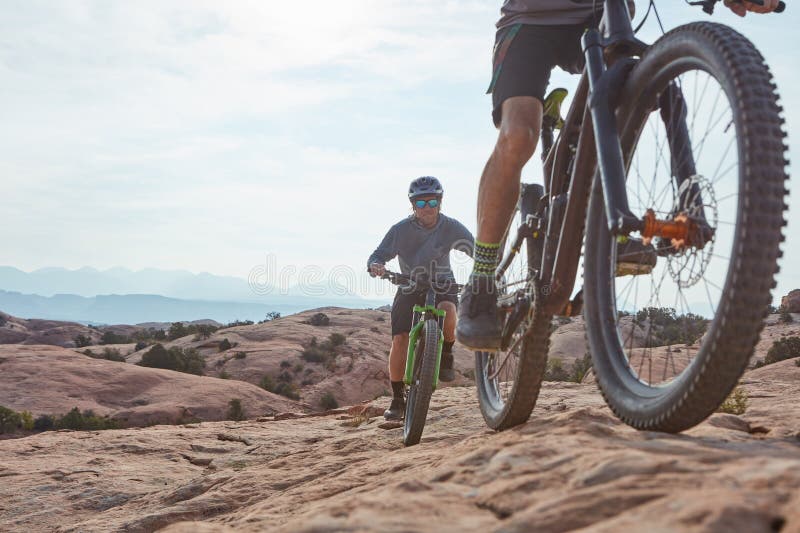 Live Your Passion. Two Athletic Men Mountain Biking through the ...