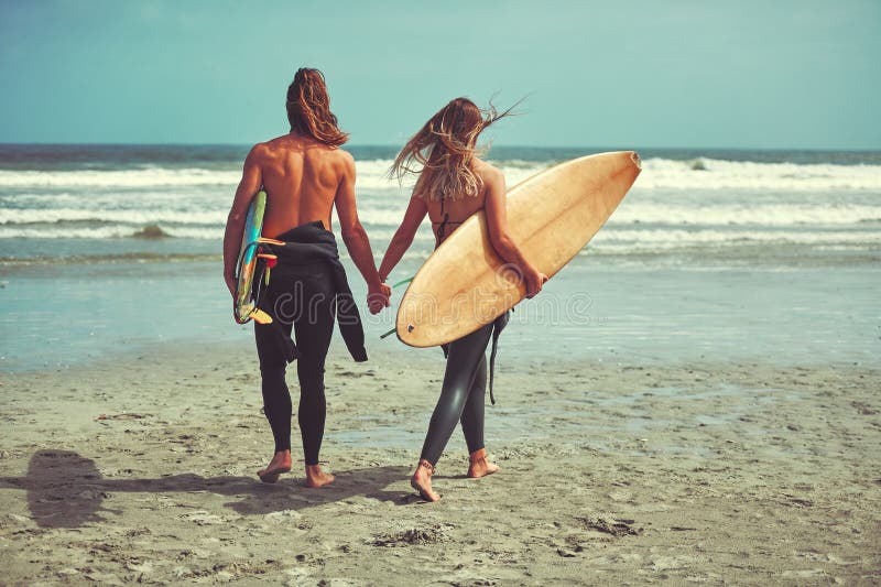 And They Lived Surfing Ever After A Young Couple Walking On The Beach