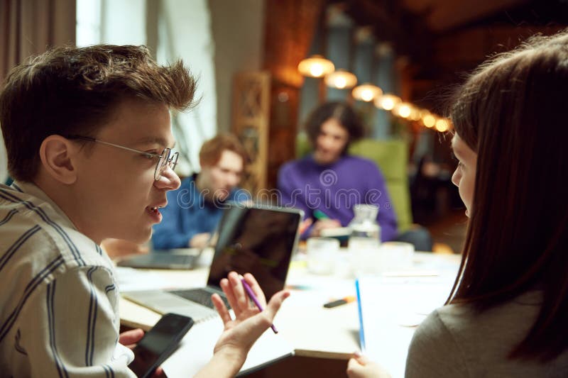 Lively Discussion. Students Gathering Together in Library and Studying ...