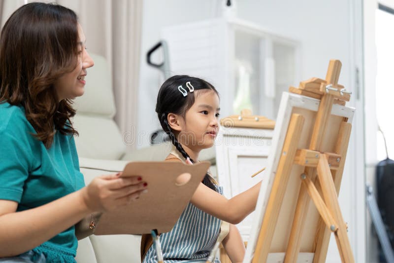 Activity of a Mother and Daughter Painting Together on Canvas Stock ...