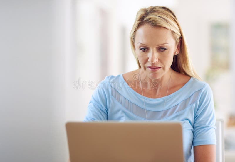 Living Connected. a Mature Woman Using a Laptop at Home. Stock Image ...