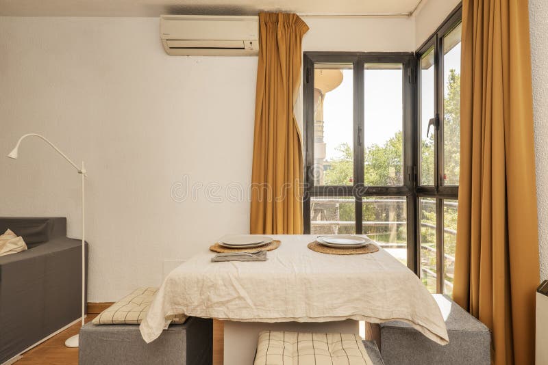 Living Room with Dining Table in a Glazed Corner with Views Stock Photo ...