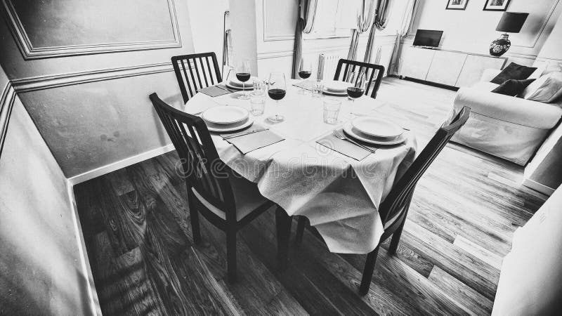 Living Room with Dining Table with Silverware and Red Wine Glasses in a ...