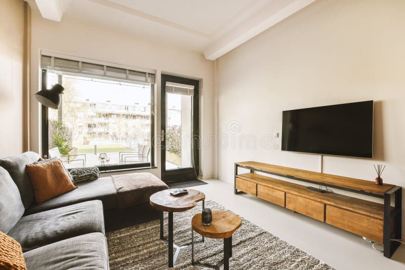 A Living Room with a Gray Couch and a Television Stock Photo - Image of ...