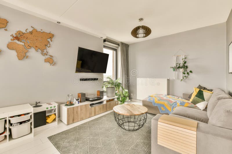 A Living Room with a Gray Couch and a Tv Stock Photo - Image of ...