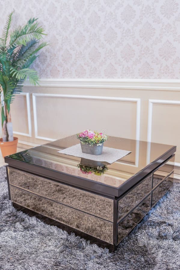 A Living Room Table with Glass Material and Small Flower Vase Stock ...