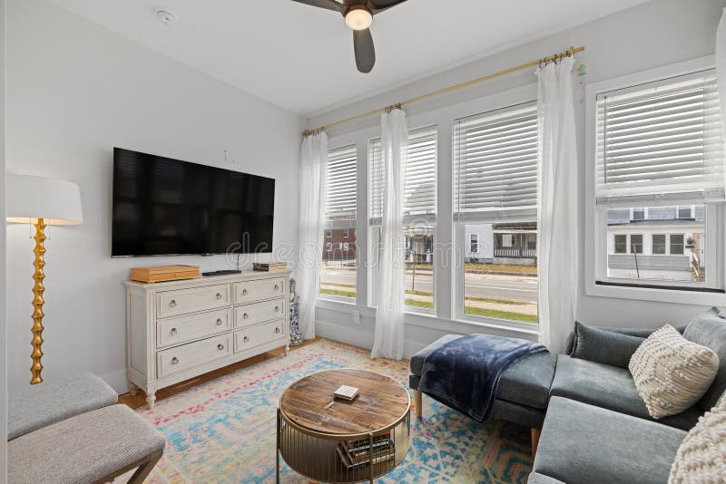 Living Room with Windows and a Big Screen TV. Stock Image - Image of ...