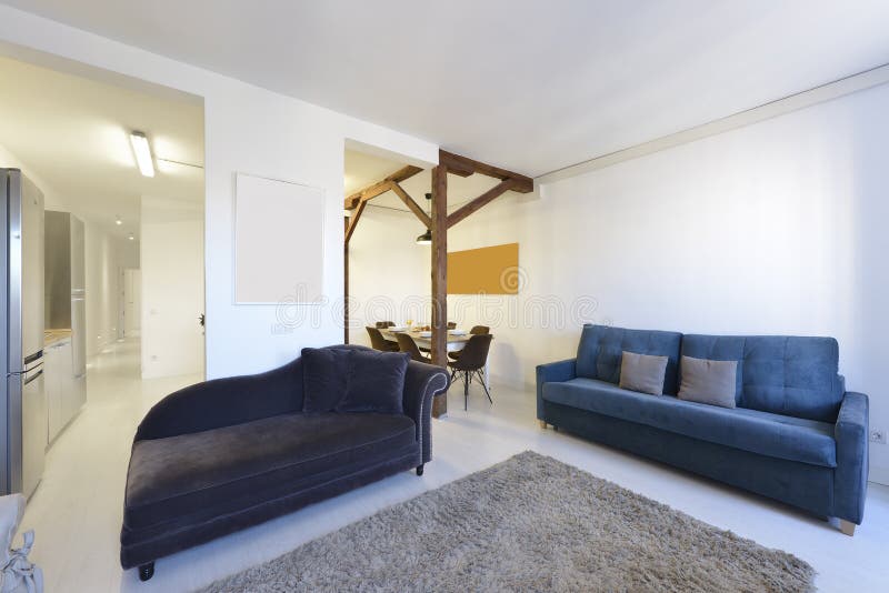 Living Room with Wooden Beams and Blue Sofas and Open Plan Kitchen with ...