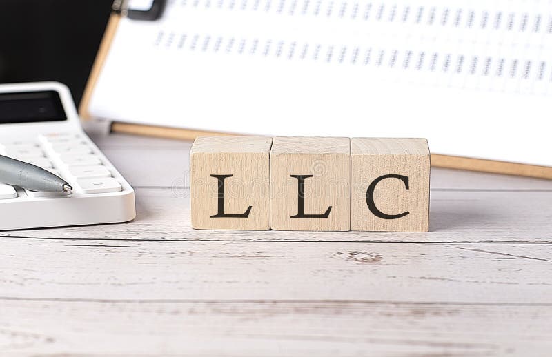 LLC Word on a Wooden Block with Clipboard and Calcuator Stock Photo ...