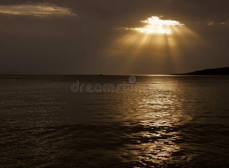 Llittle boat and Gods rays stock photo. Image of calm - 19910932